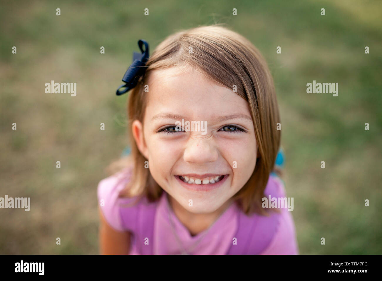 High angle portrait of smiling girl on grassy field Stock Photo - Alamy
