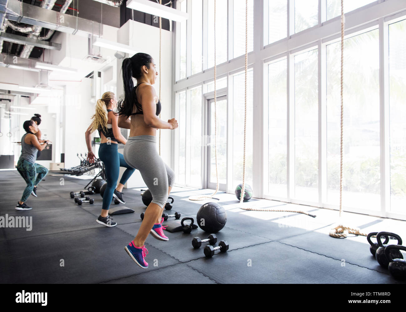 Female athletes jogging in crossfit gym on sunny day Stock Photo - Alamy