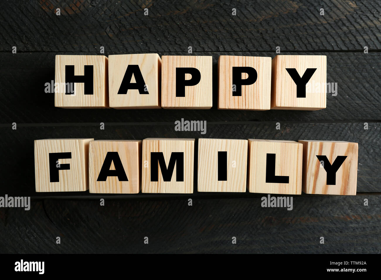 Words HAPPY FAMILY on dark grey background Stock Photo - Alamy