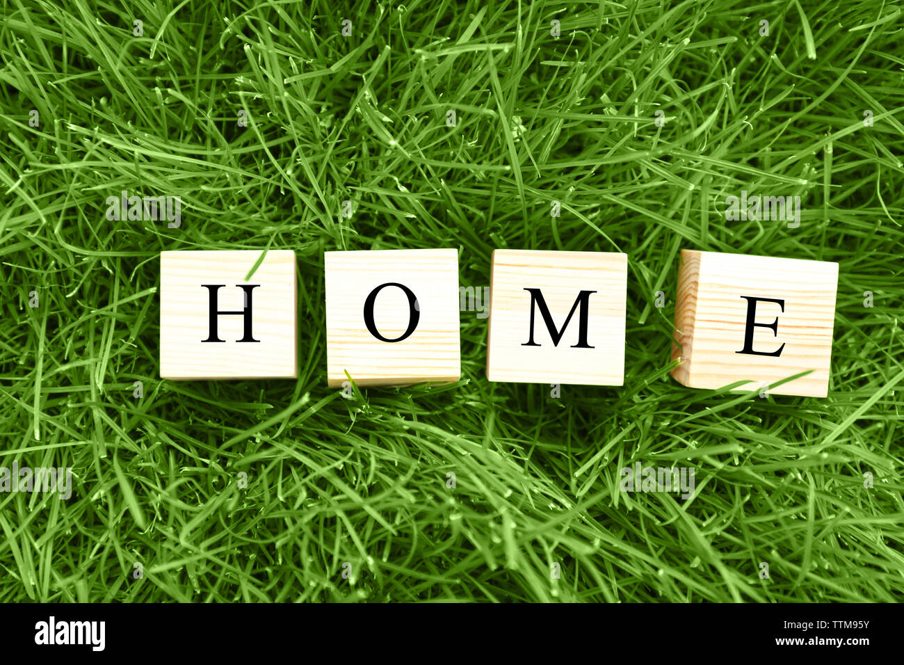 Word HOME on green grass Stock Photo - Alamy