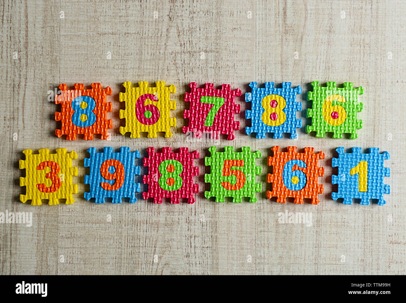 Color numbers on wooden table Stock Photo - Alamy