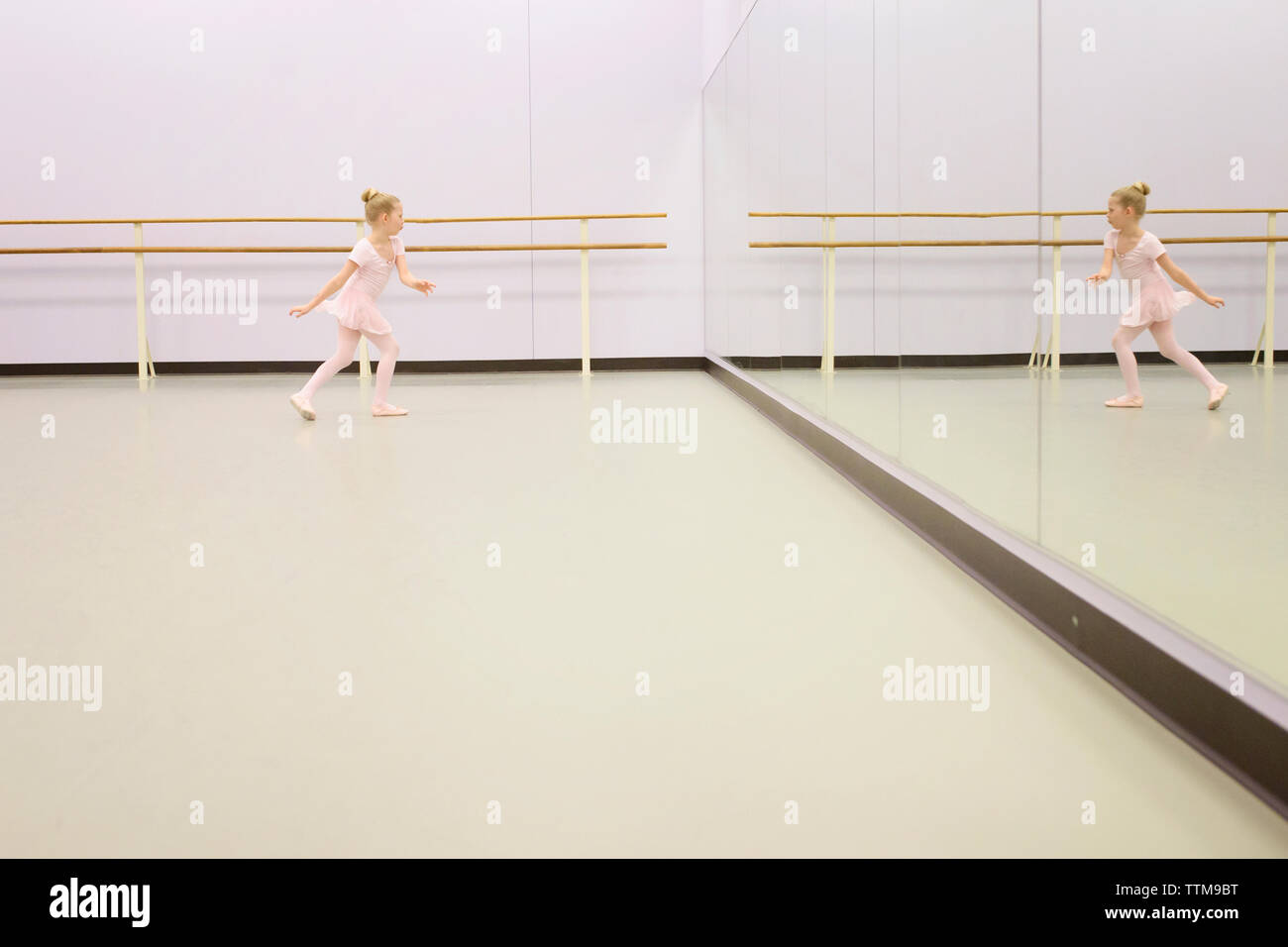 Girl practicing ballet in front of mirror at ballet studio Stock Photo ...