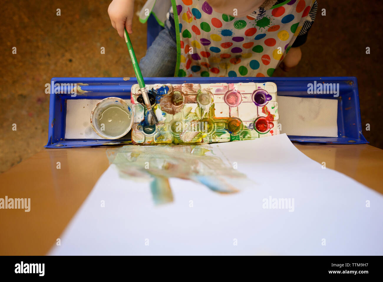 Overhead view of boy painting while sitting at home Stock Photo - Alamy