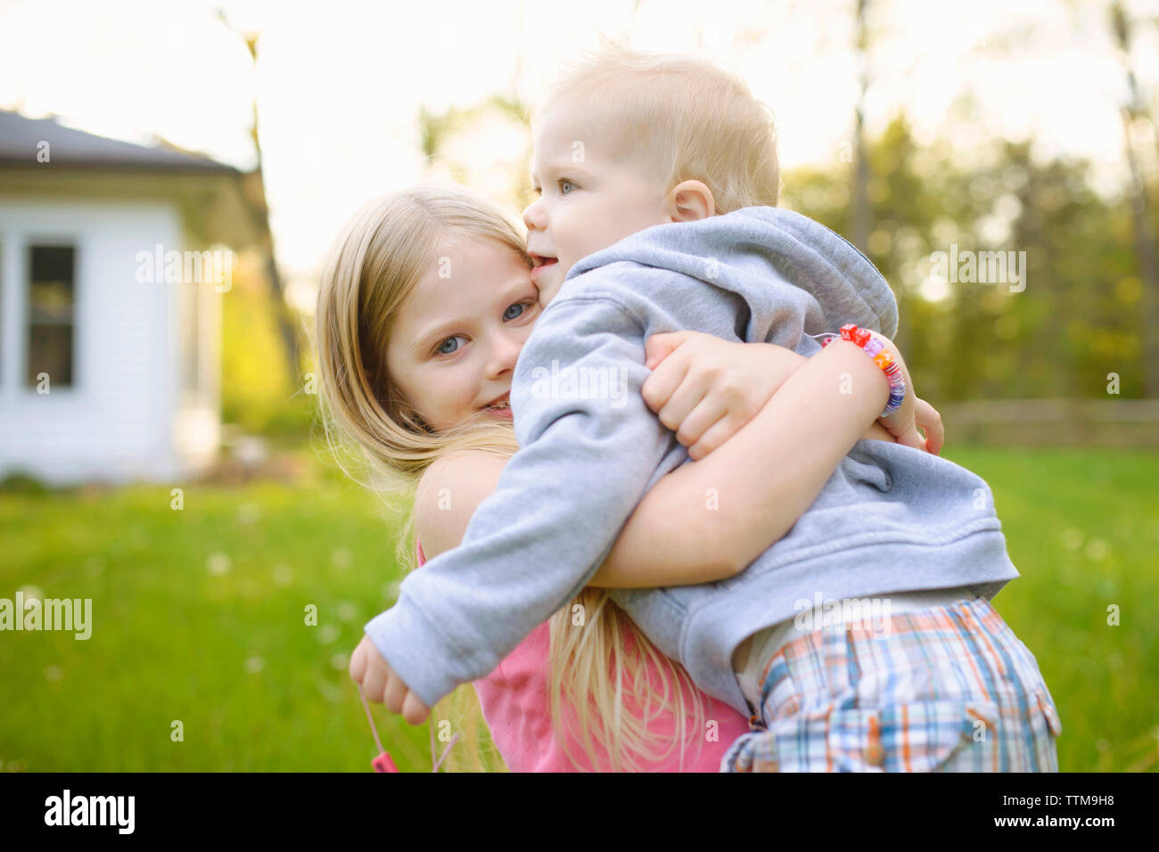 Girl and boy standing side by side hi-res stock photography and images ...