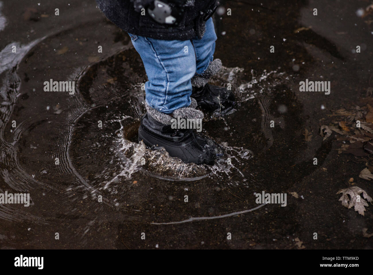Boy jumping in puddle hi-res stock photography and images - Alamy