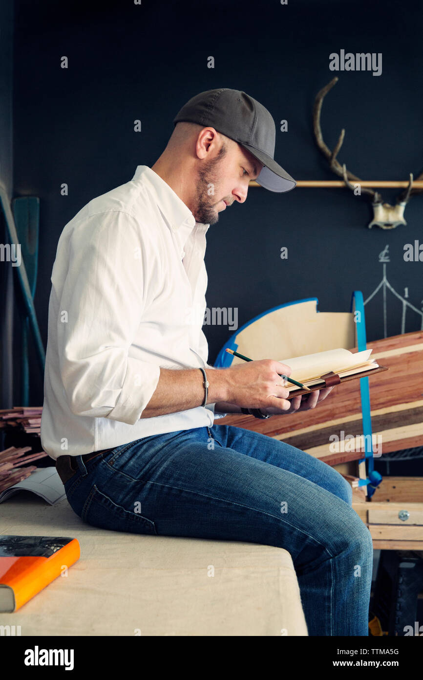 Craftsperson taking notes Stock Photo - Alamy