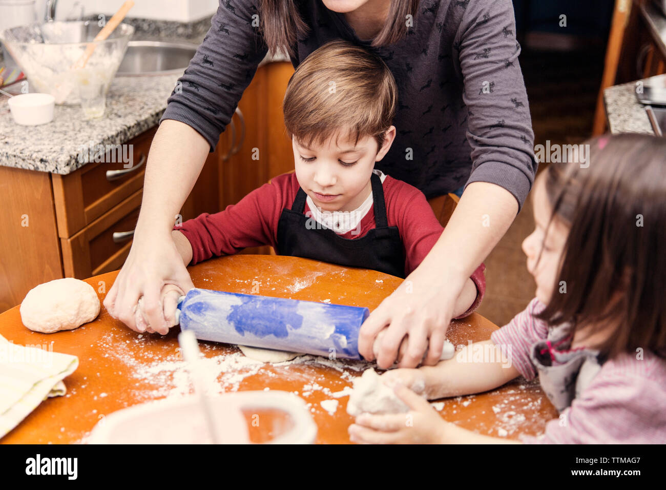 Daughter and son cooking in kitchen hi-res stock photography and images ...