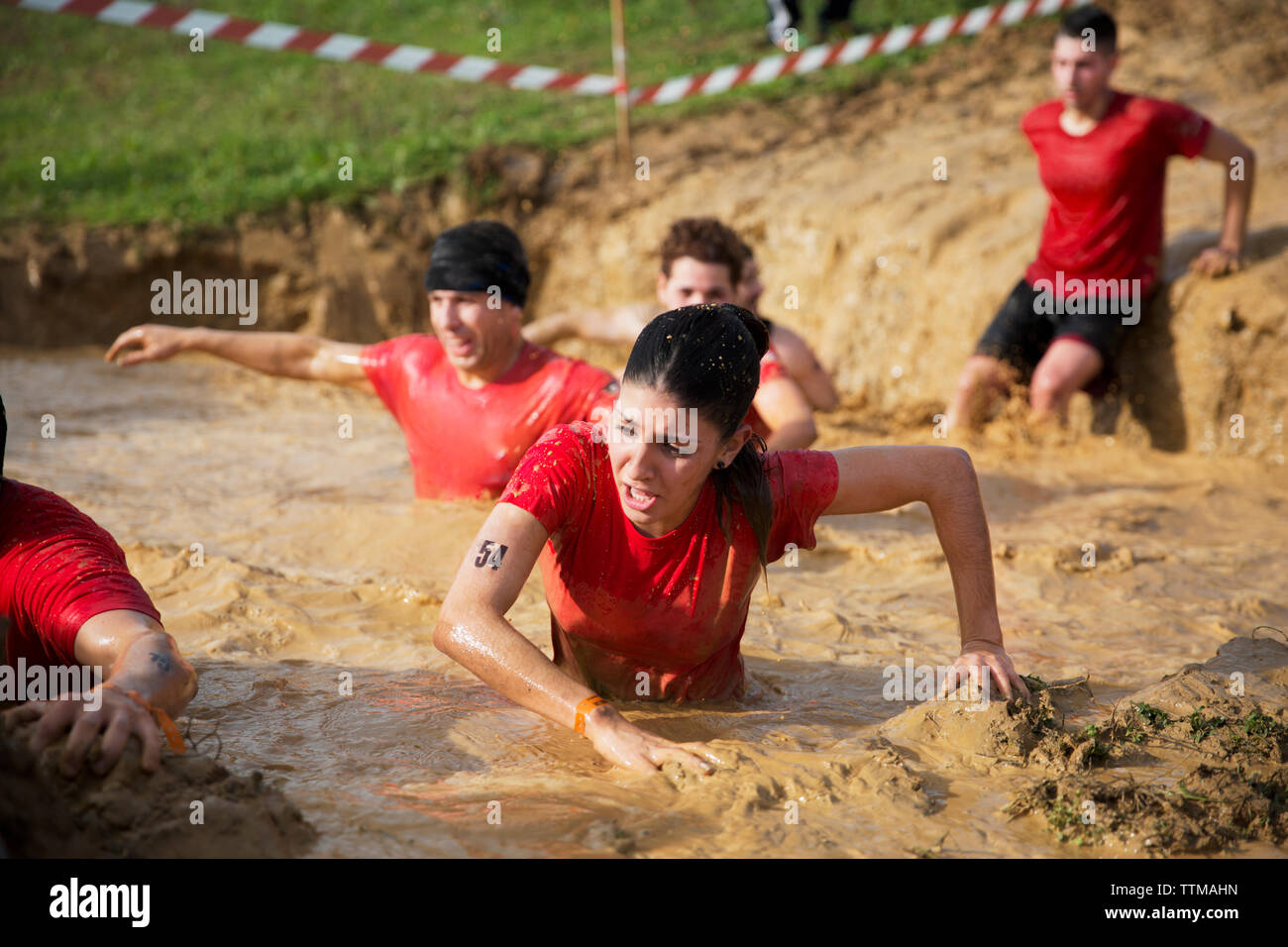 Team crossing mud pit during race Stock Photo - Alamy