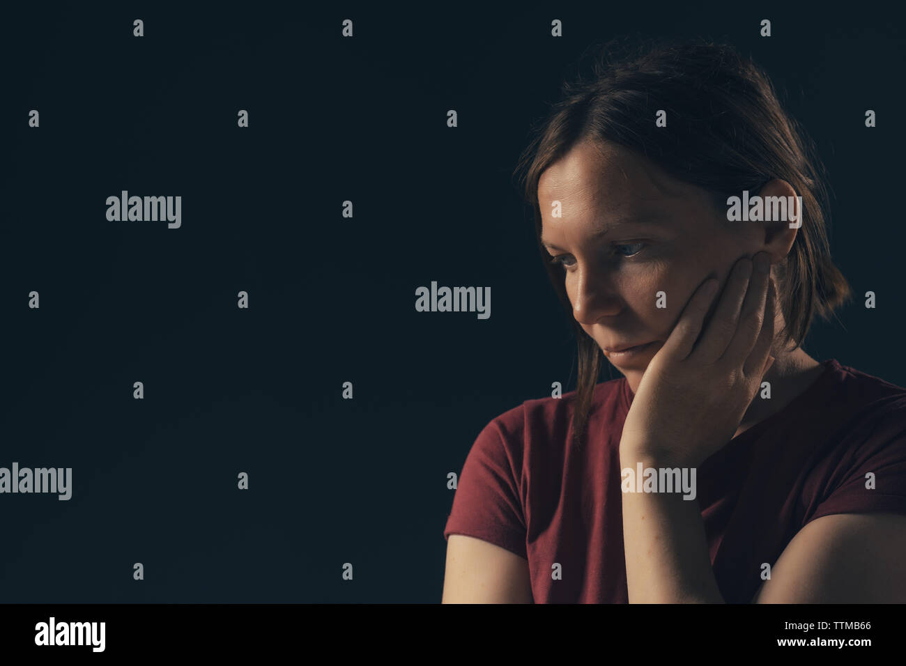 Low key portrait of depressed sad woman Stock Photo - Alamy
