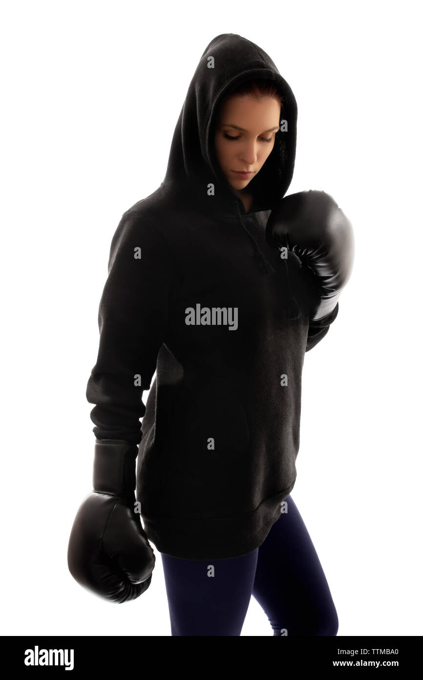 Young beautiful female boxer dressed in black looking down, with a ...