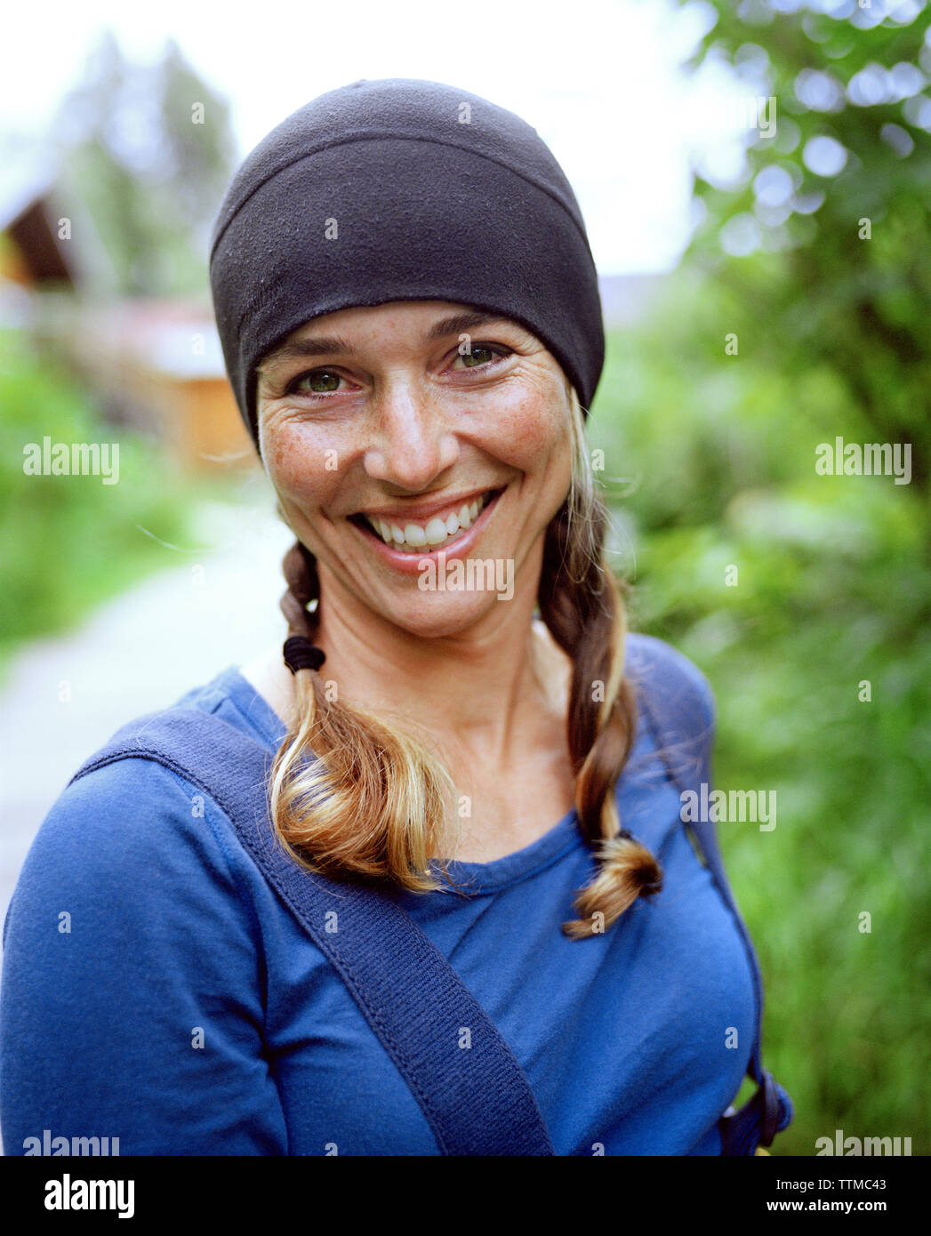 USA, Alaska, Redoubt Bay, a young woman fishing guide smiles at the ...
