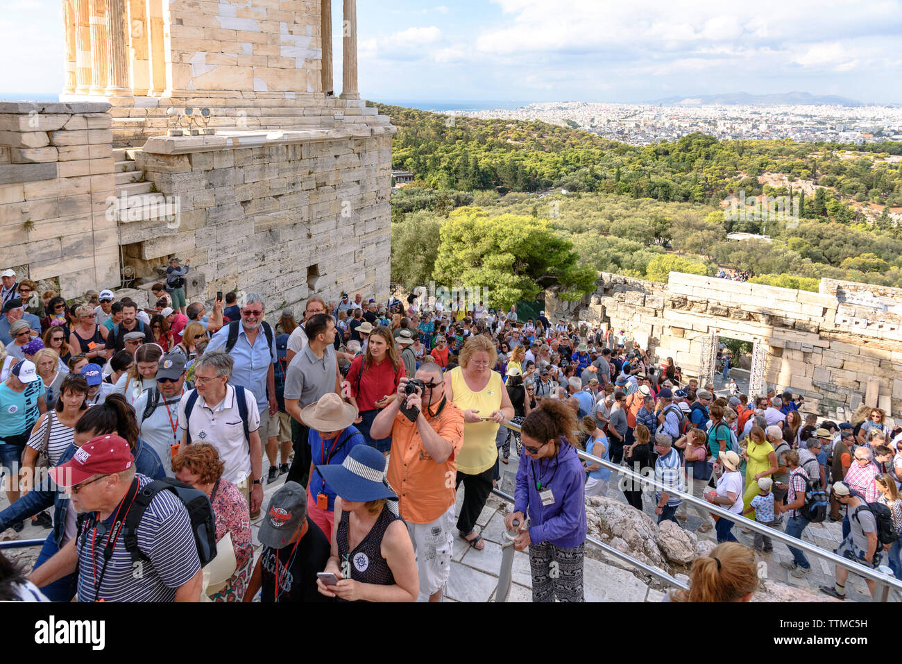 The Acropolis of Athens crowded with tourists on a sunny summer morning ...