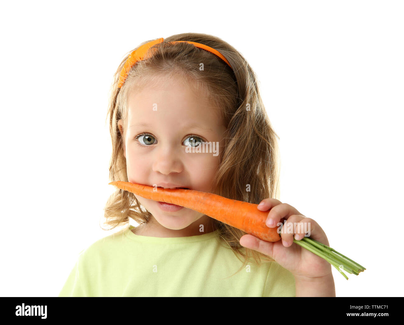 Beautiful girl eating carrot, isolated on white Stock Photo - Alamy