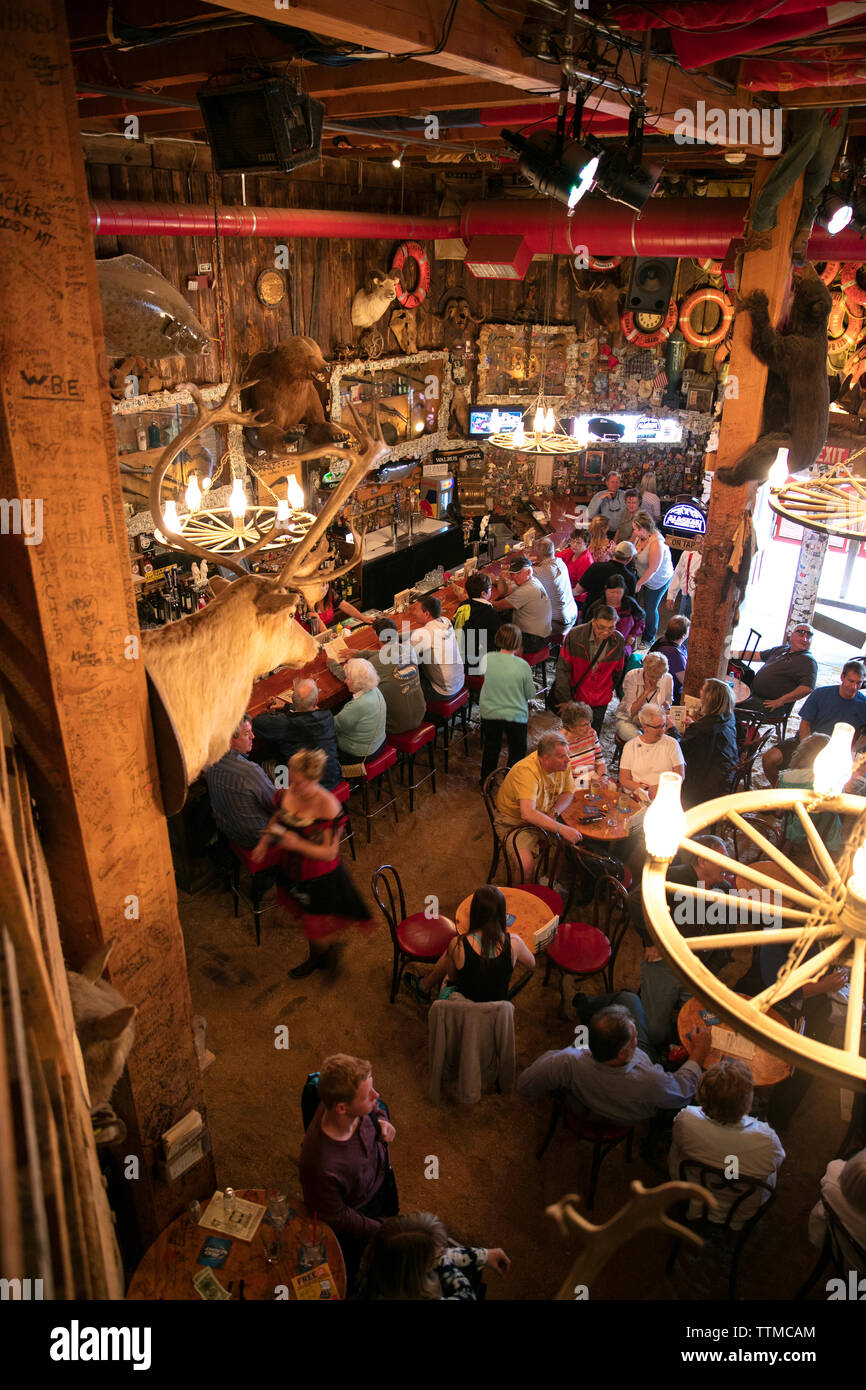 USA, Alaska, Juneau, individuals gather and dine inside of the Red Dog ...