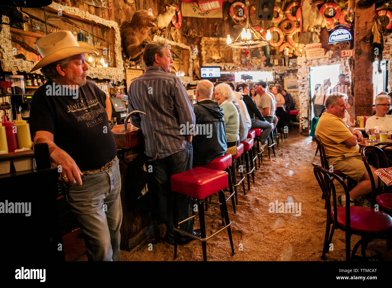 USA, Alaska, Juneau, individuals gather and dine inside of the Red Dog ...