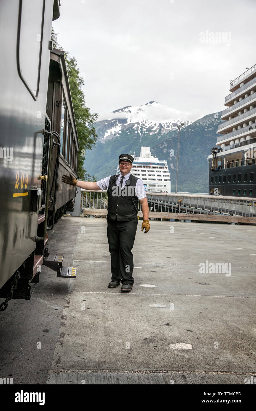 USA, Alaska, Sitka, one of the train conductors prepares to board the ...