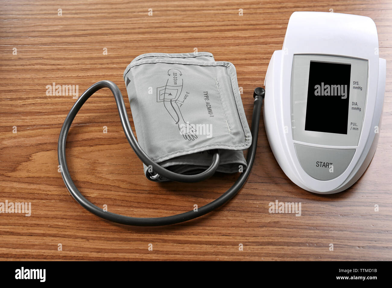Digital blood pressure monitor on wooden background Stock Photo - Alamy