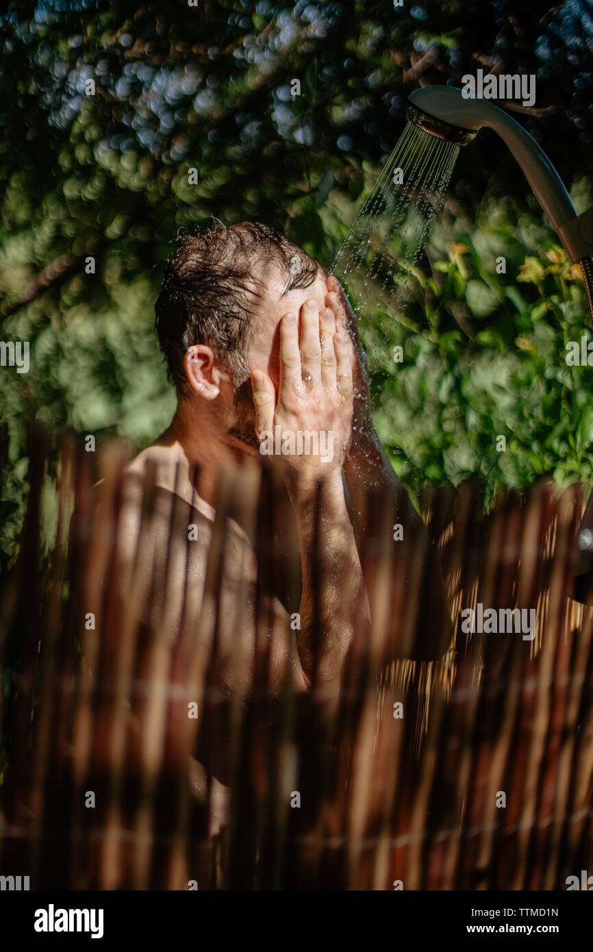photo of man taking an outdoor shower Stock Photo - Alamy