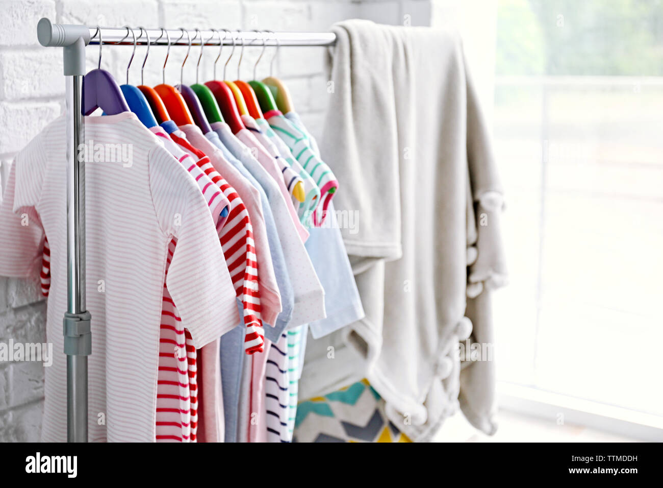 Clothes for kids on hangers Stock Photo - Alamy