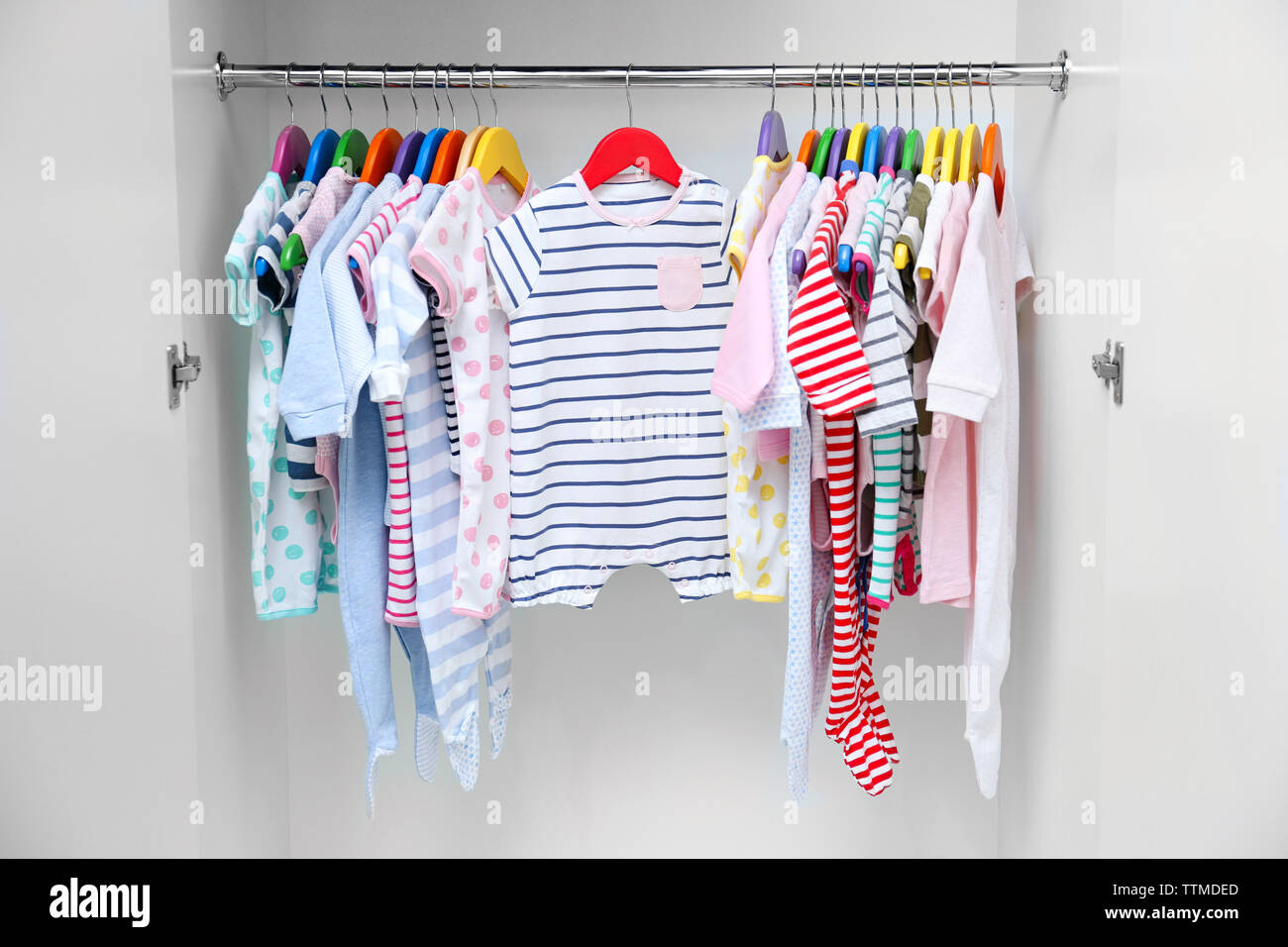 Clothes for kids in wardrobe Stock Photo - Alamy