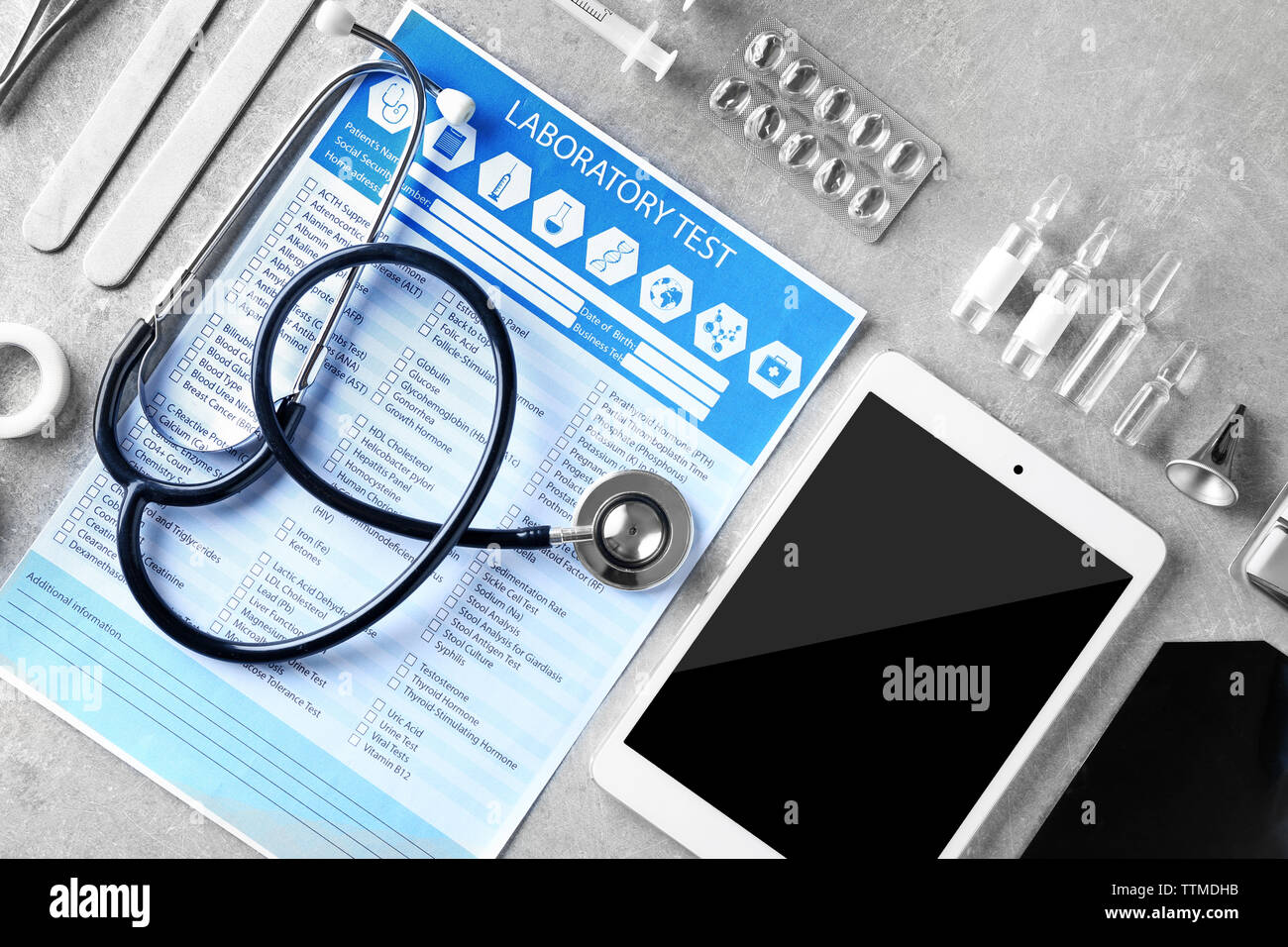 Medical tools set with tablet on gray background Stock Photo - Alamy