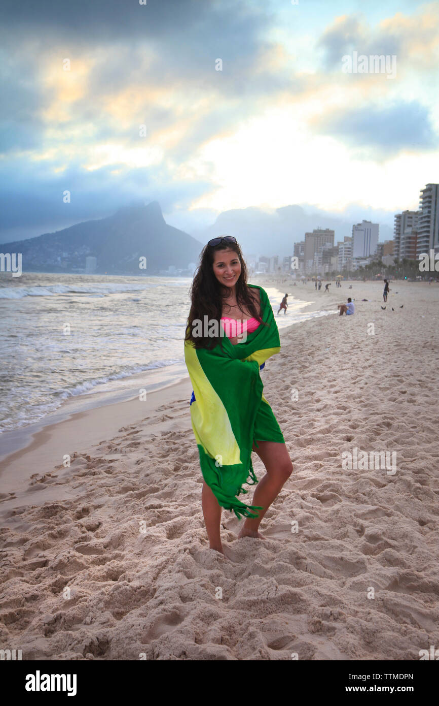 BRAZIL, Rio de Janiero, a young girl wraps herself in the Brazilian ...