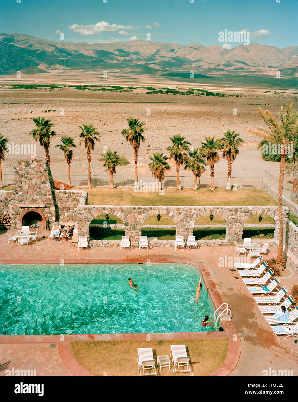 USA, California, Death Valley National Park, family in swimming pool ...
