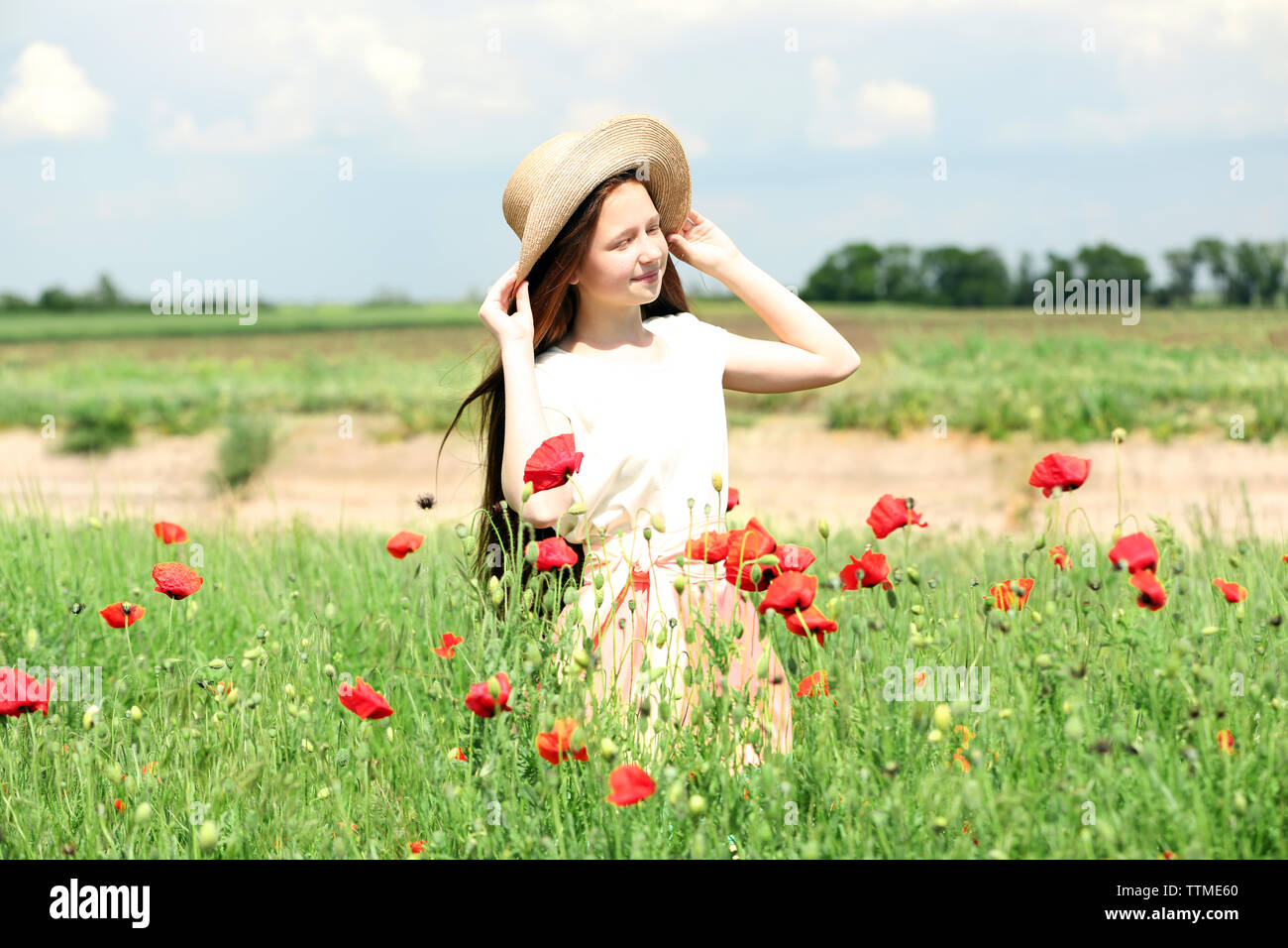 Beautiful girl in poppy field Stock Photo - Alamy
