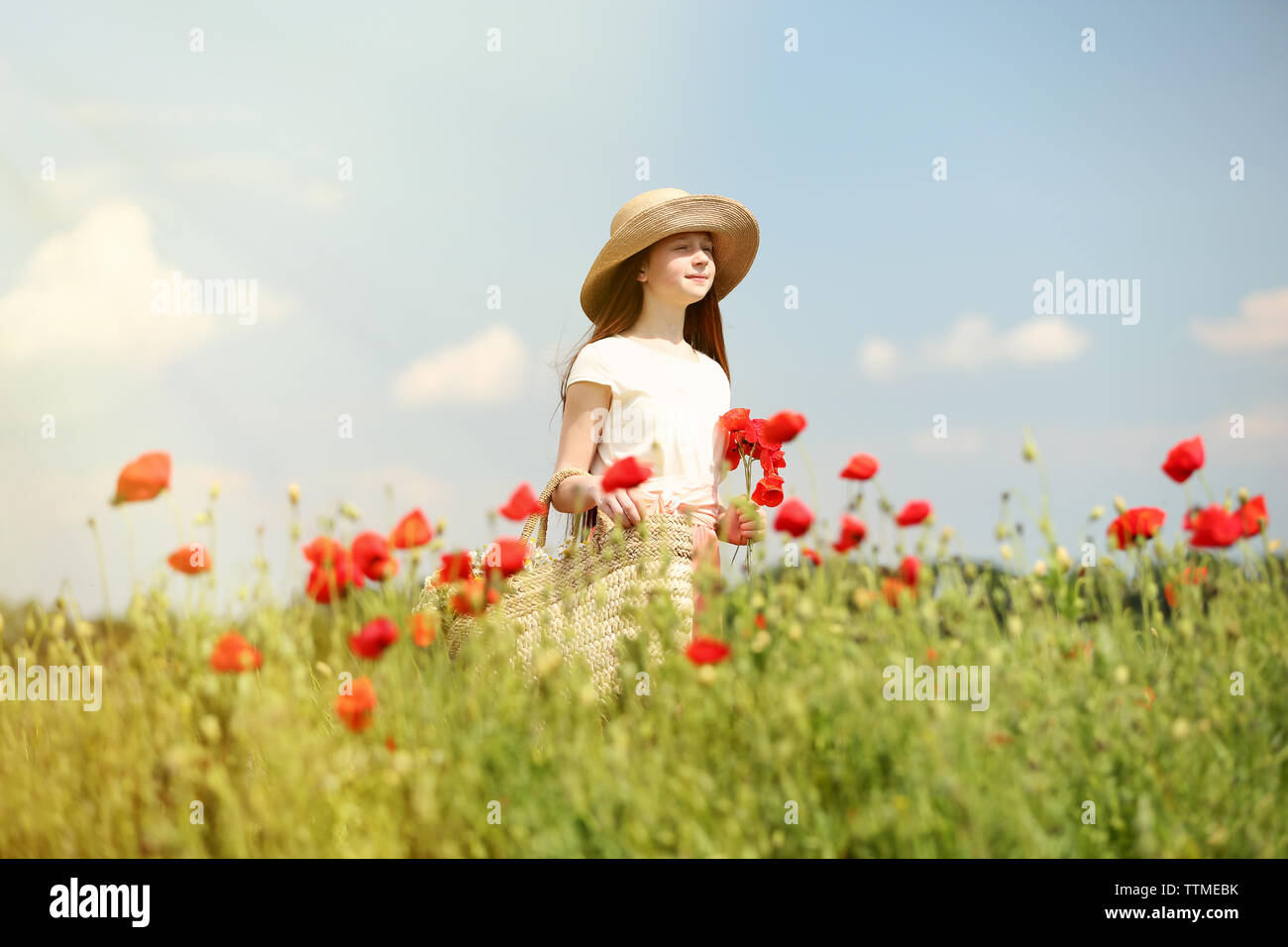 Beautiful girl in poppy field Stock Photo - Alamy