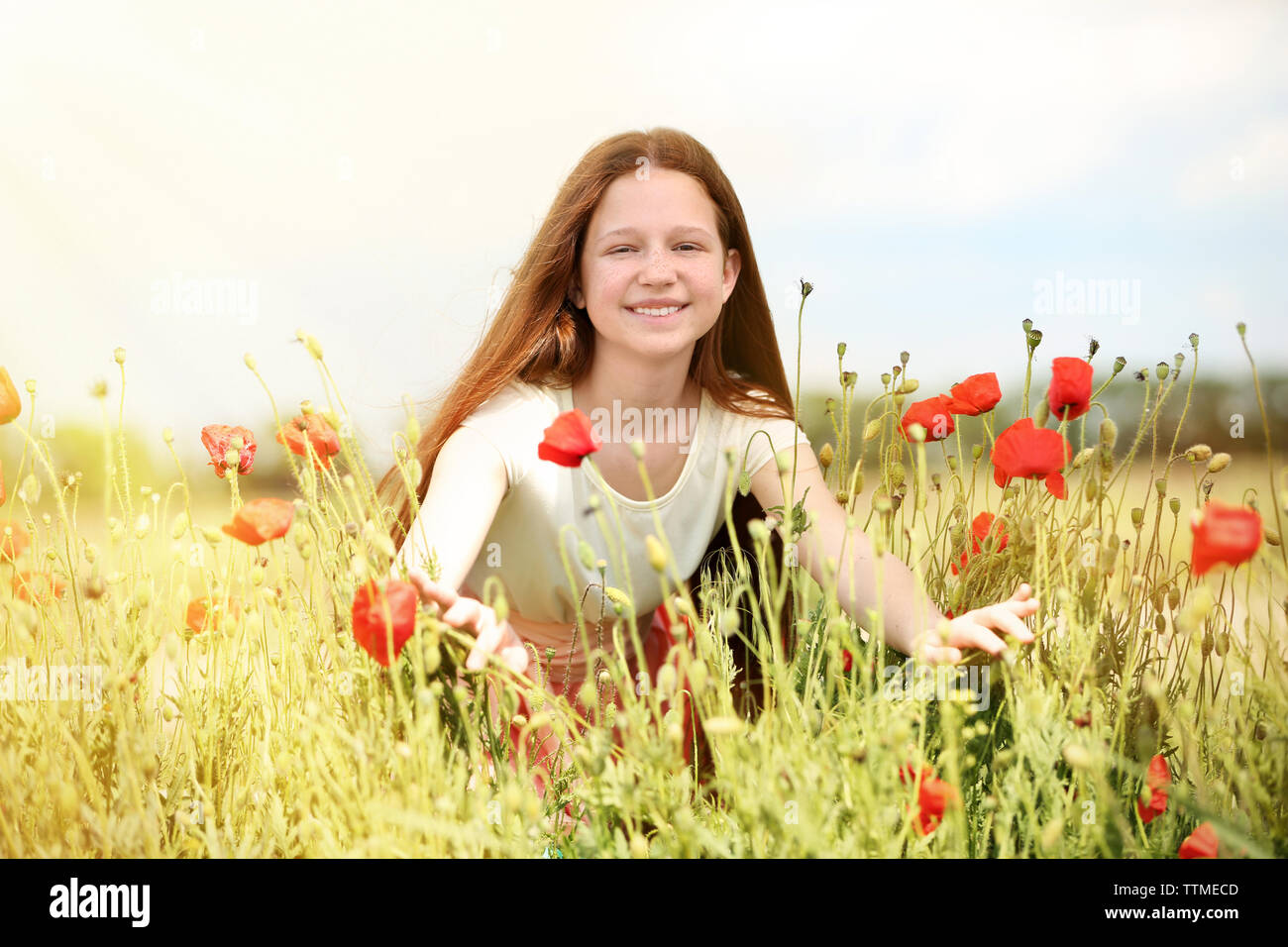 Beautiful girl in poppy field Stock Photo - Alamy