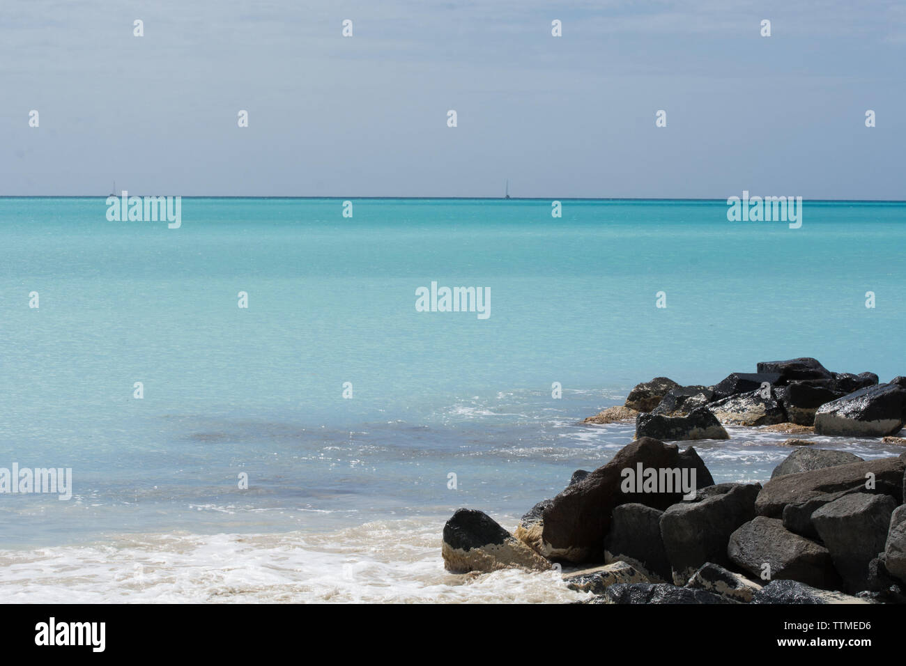 A Caribbean Beach with crystal clear, blue water. Beautiful blue sky ...