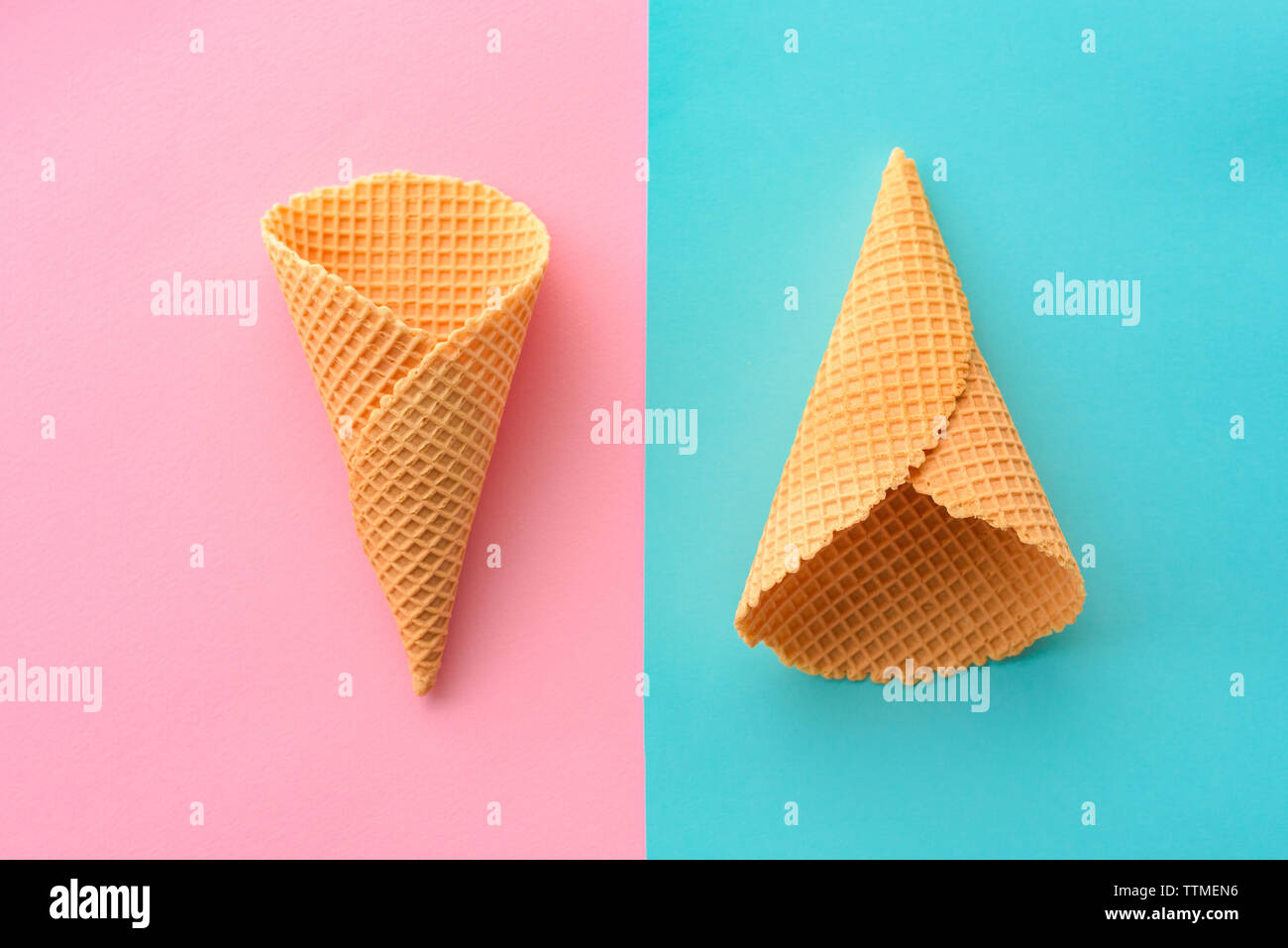Ice Cream Waffle Cones On Pastel Pink And Blue Background Top View