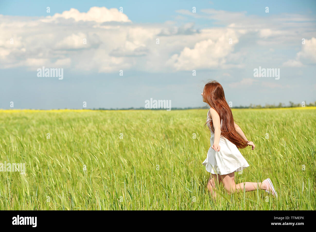Sweet girl in spring meadow Stock Photo - Alamy