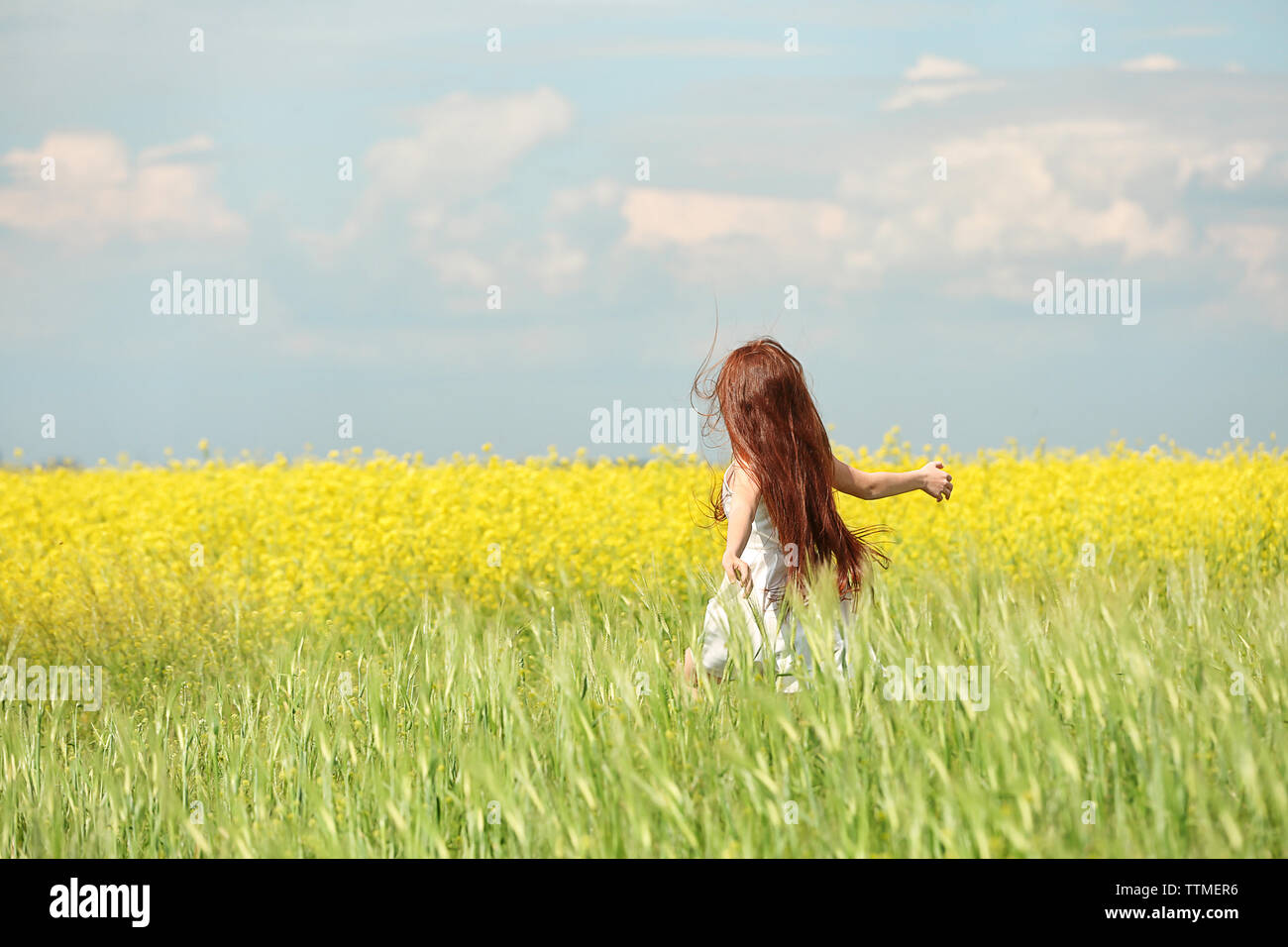 Sweet girl in spring meadow Stock Photo - Alamy