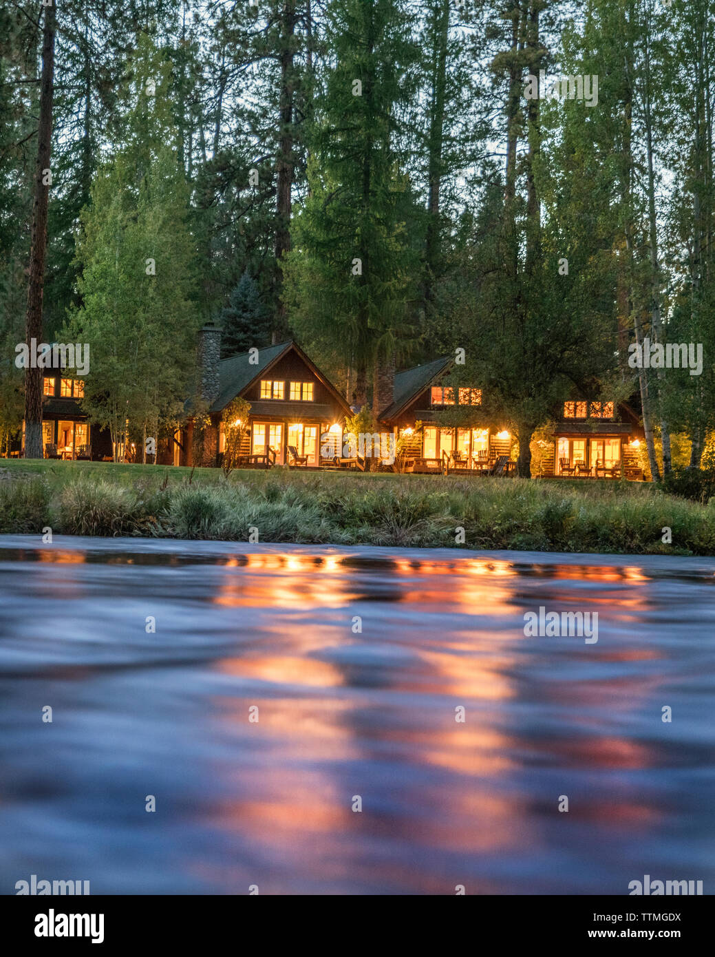 USA, Oregon, Camp Sherman, Metolius River Resort, View of cabins from ...