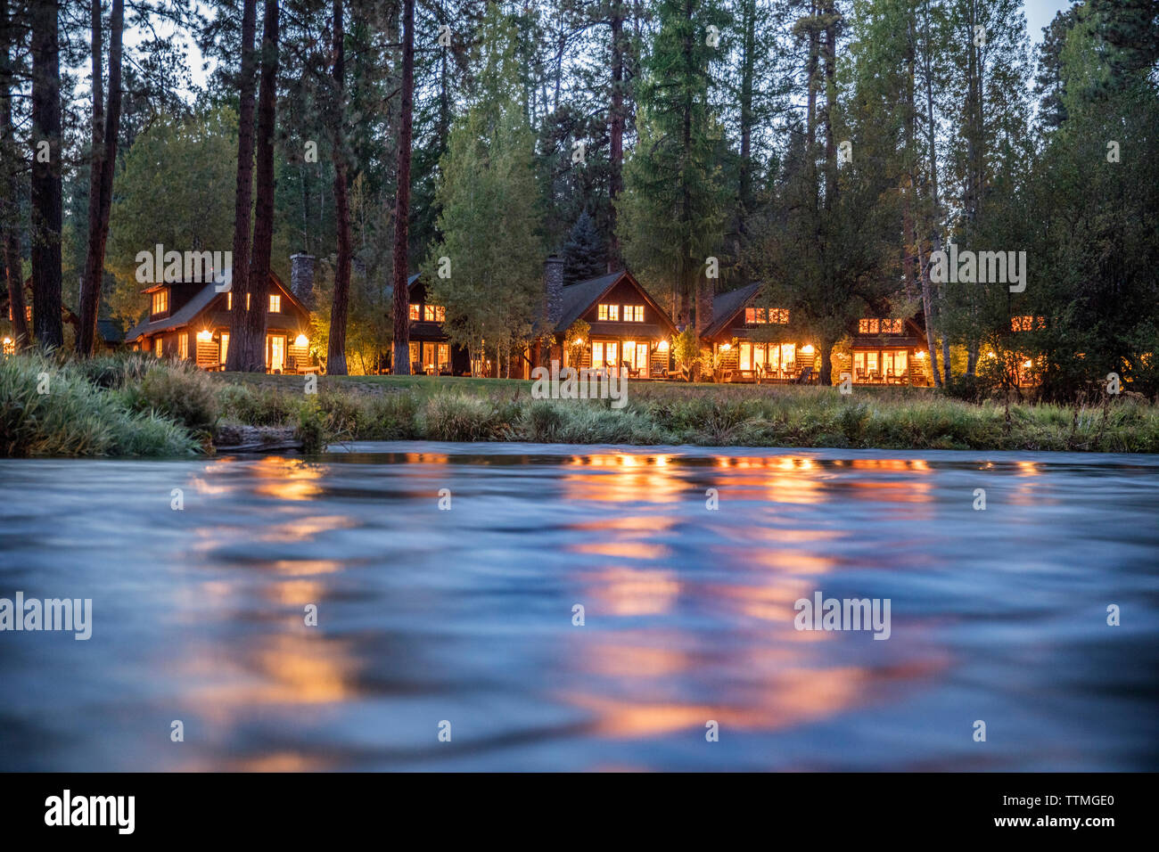 USA, Oregon, Camp Sherman, Metolius River Resort, View of cabins from ...