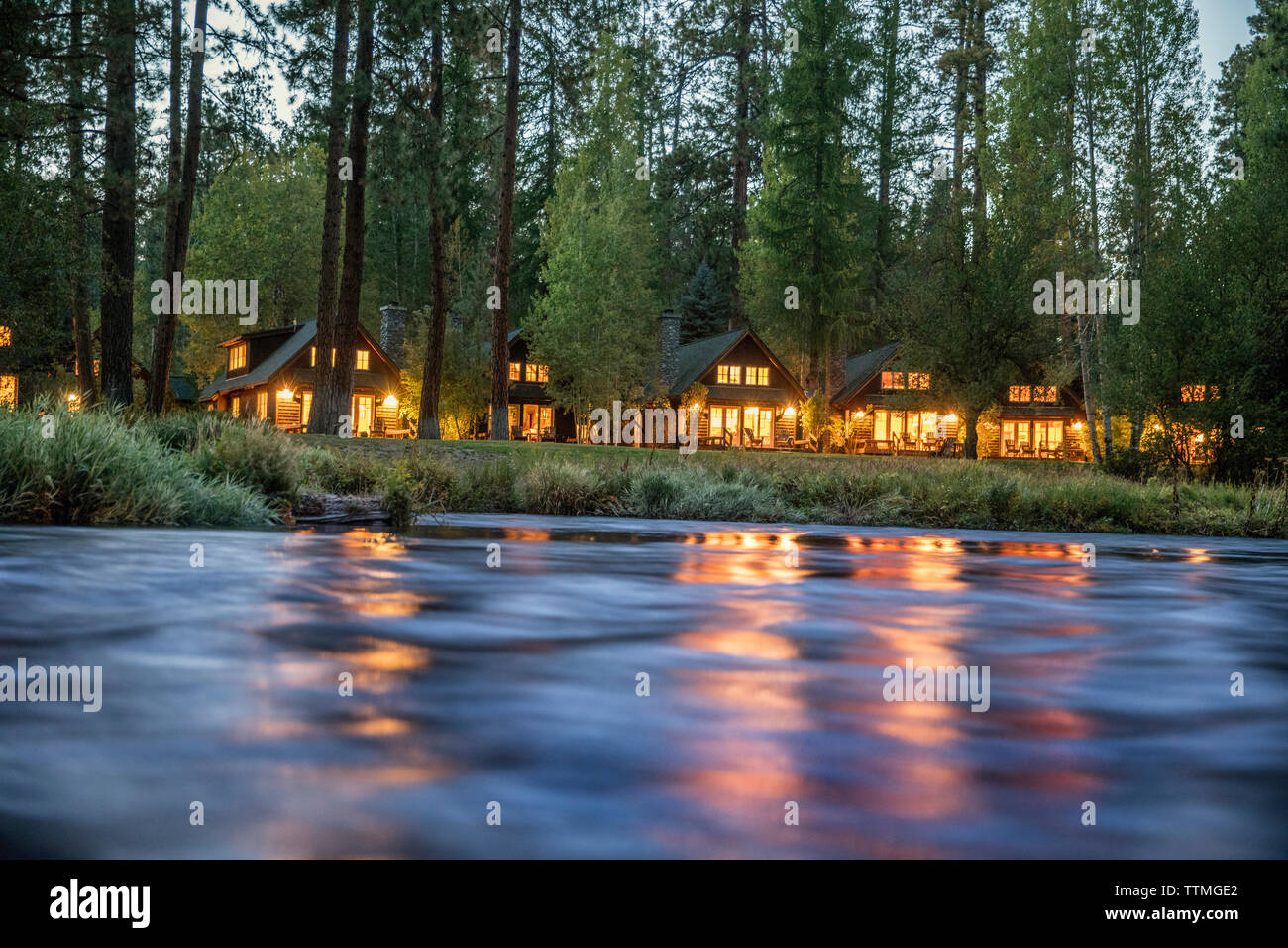 USA, Oregon, Camp Sherman, Metolius River Resort, View of cabins from ...
