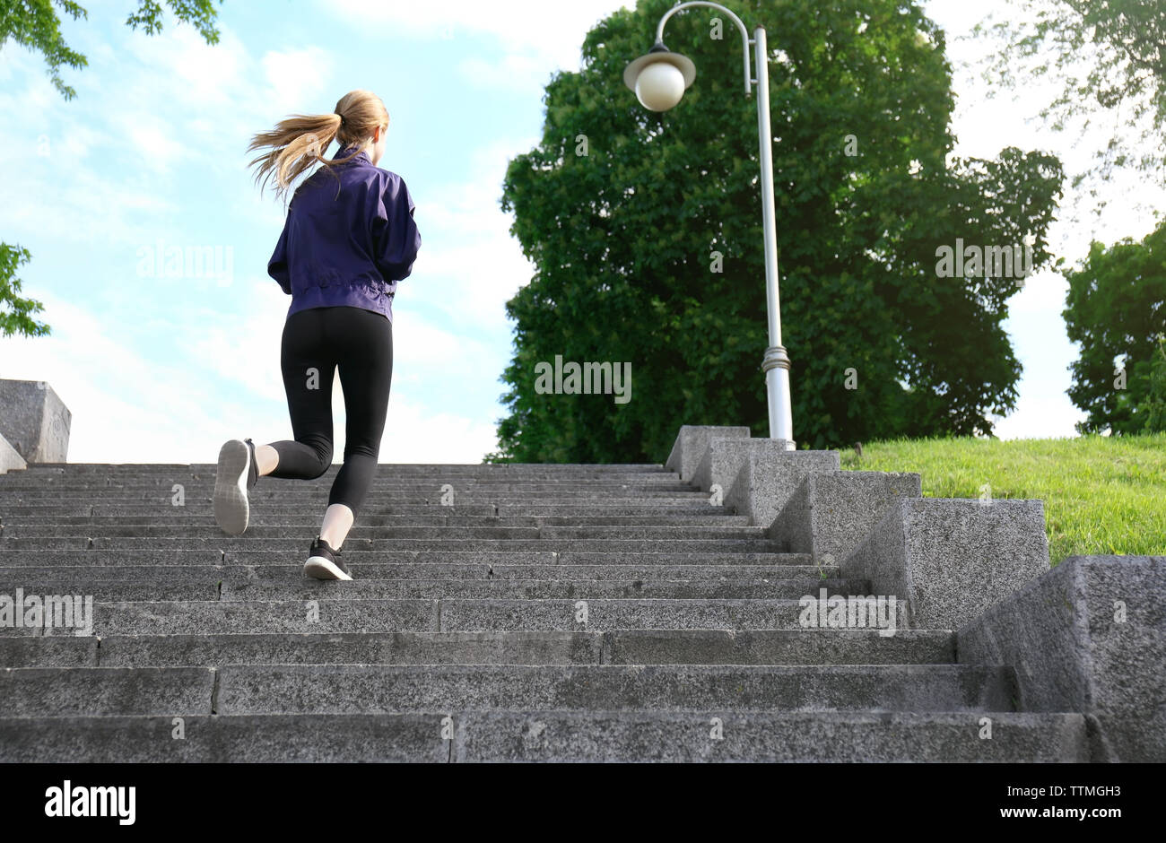 Black woman running up stairs hi-res stock photography and images - Alamy