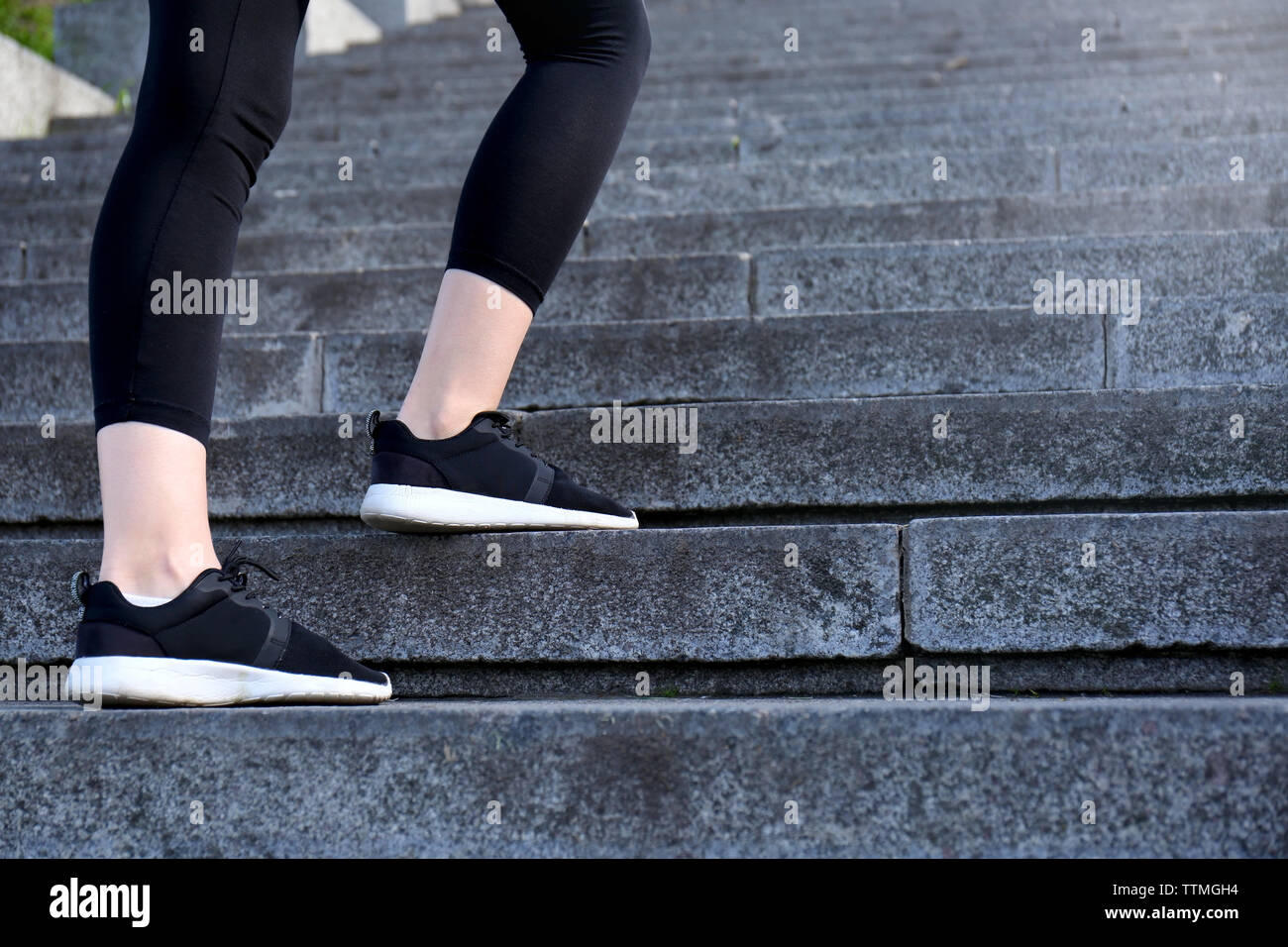 Black woman running up stairs hi-res stock photography and images - Alamy