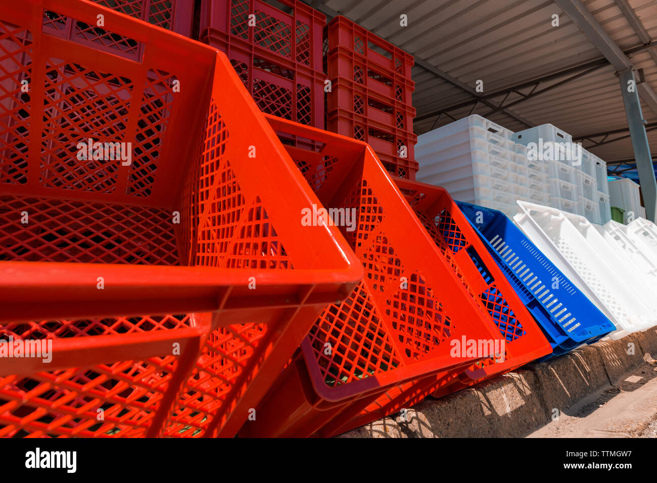 Plastic crates in stacked warehouse - red, blue and white Stock Photo ...
