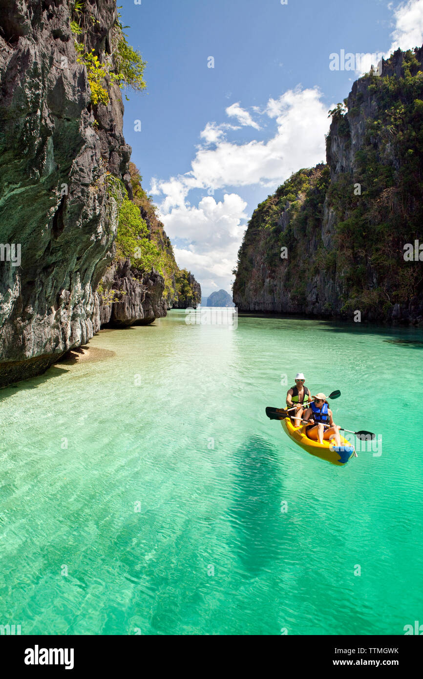 PHILIPPINES, Palawan, El Nido, Miniloc Island, tourists kayak through ...