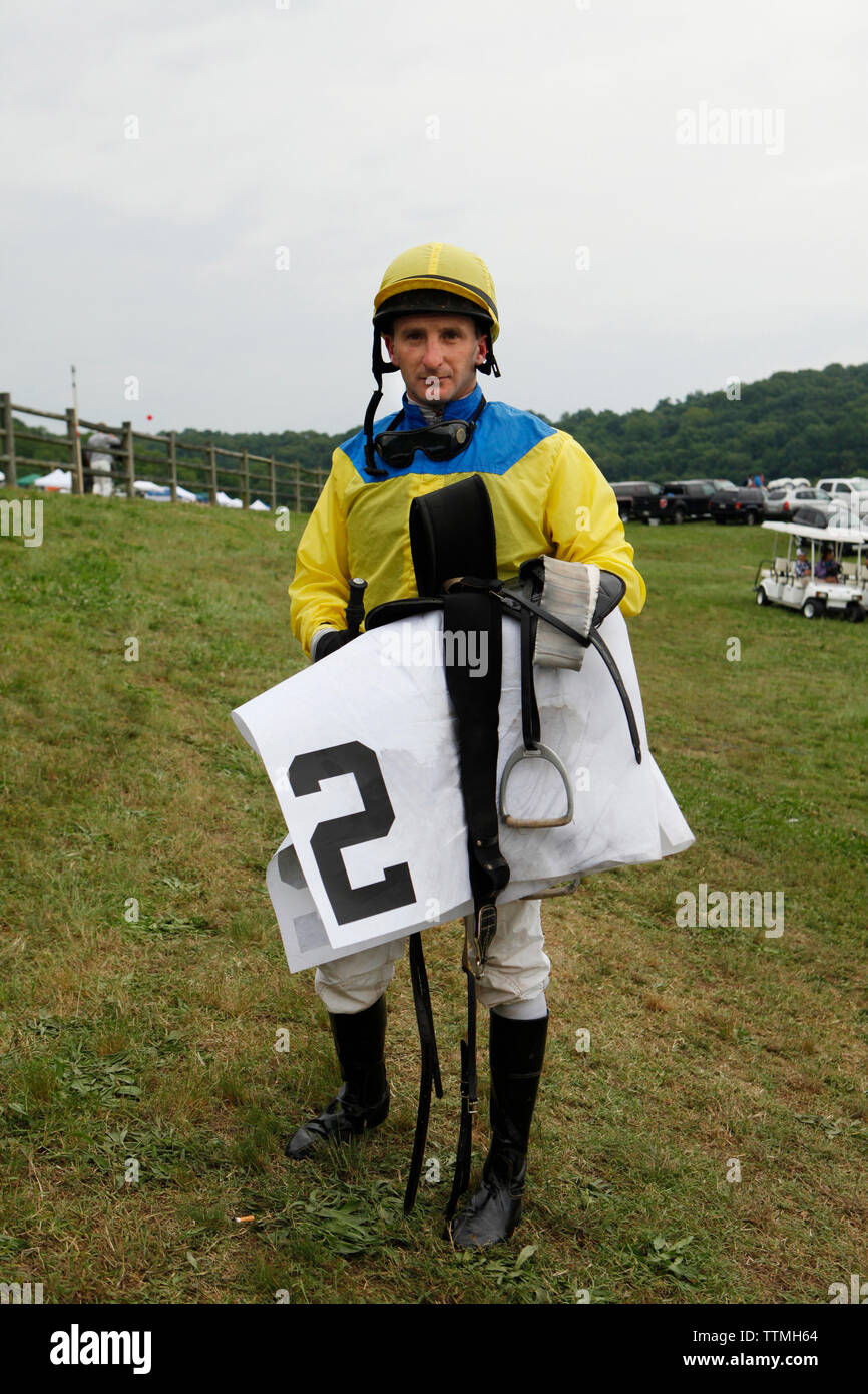 USA, Tennessee, Nashville, Iroquois Steeplechase, a jocky stands near ...
