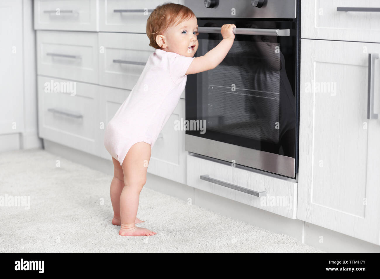 Child playing with electric oven Stock Photo - Alamy