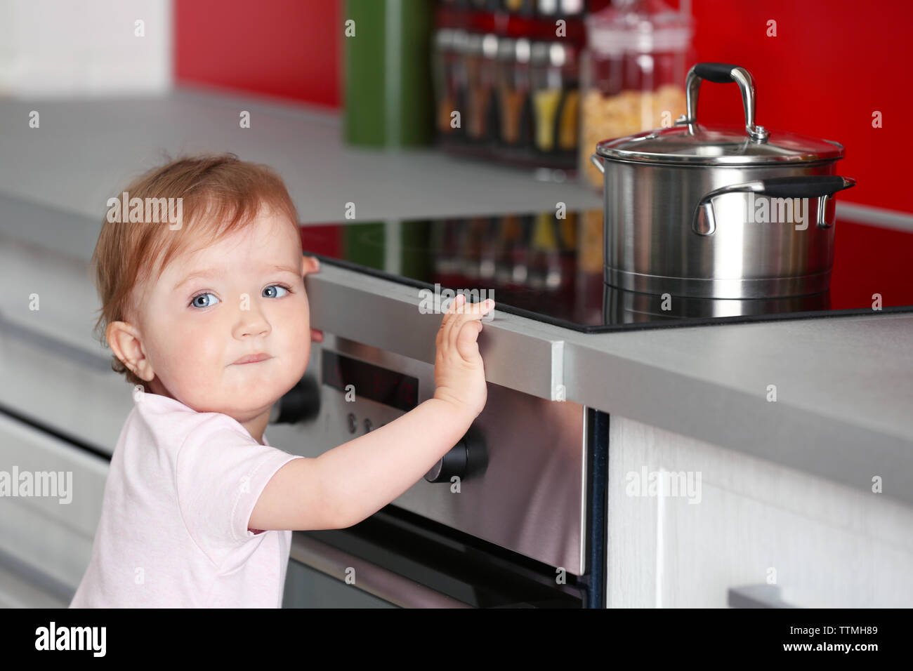 Child playing with electric oven Stock Photo - Alamy