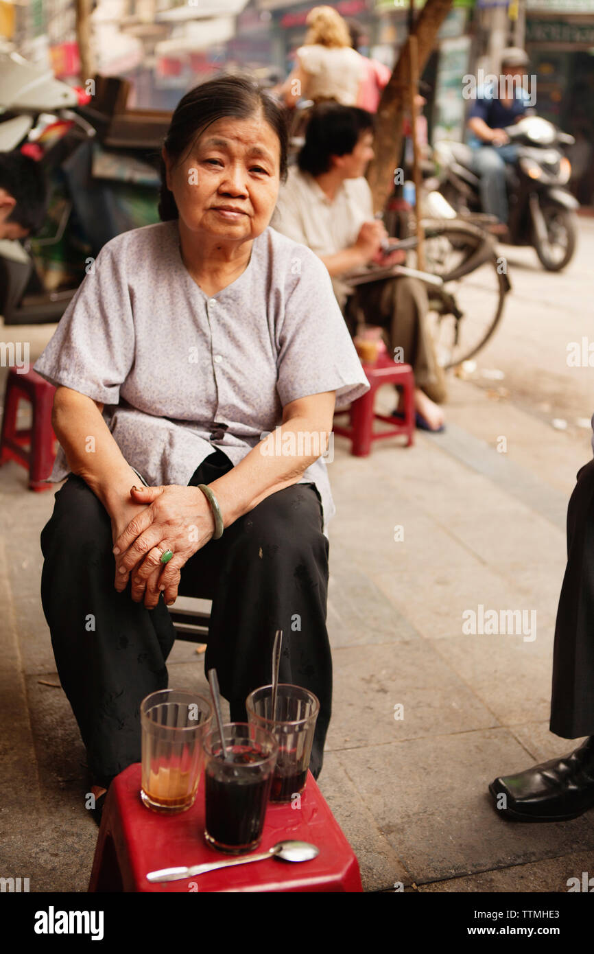 VIETNAM, Hanoi, a portrait of Miss Thai, the owner of Cafe Nang sitting ...