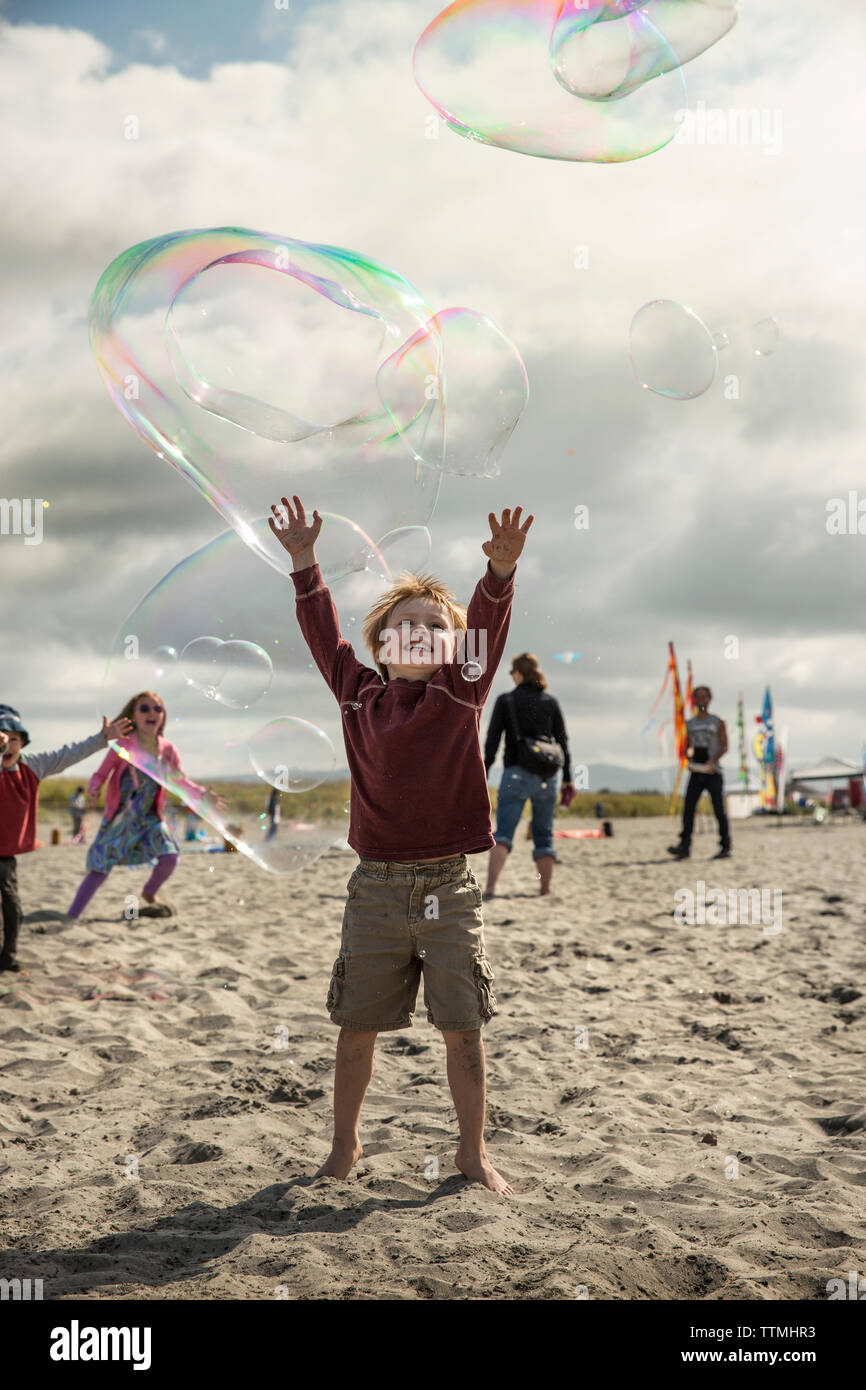 Boy chasing bubbles hi-res stock photography and images - Alamy