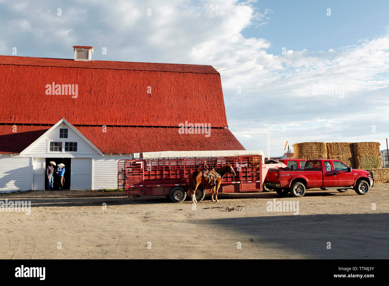 USA, Wyoming, Encampment, a cowboy and cowgirl stand in the doorway of ...
