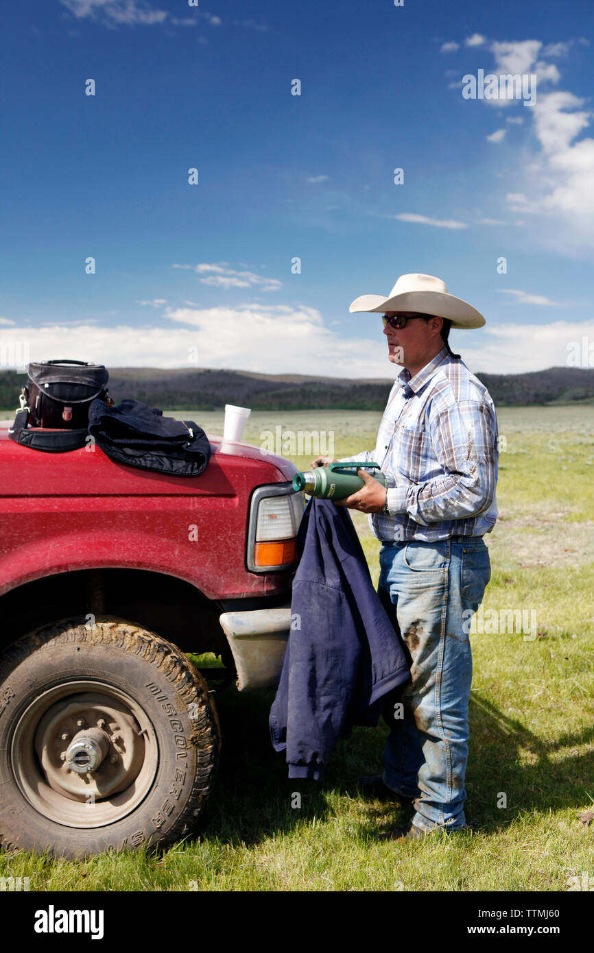 USA, Wyoming, Encampment, a cowboy gets ready to have some coffee, Big ...