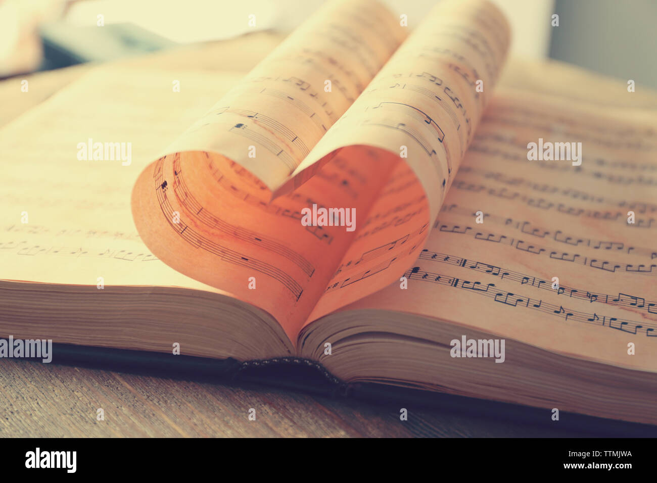 Heart shaped music notes sheets Stock Photo - Alamy