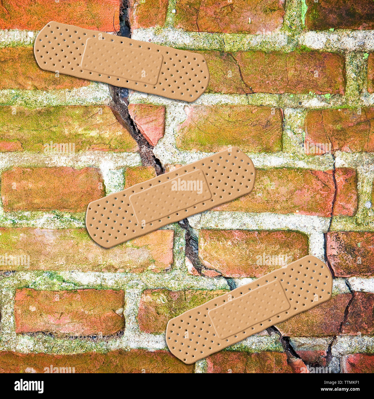 Renovation of an old cracked brick wall - concept image with bandaid ...